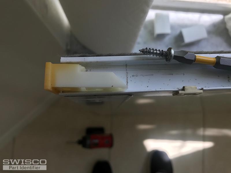 Clip that screws to the top of operative sash and retains spring ...