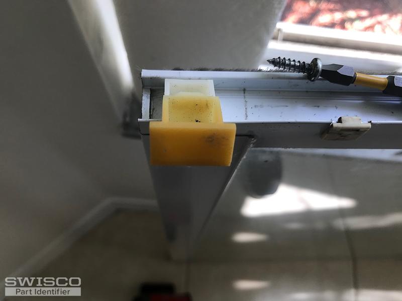 Clip that screws to the top of operative sash and retains spring ...