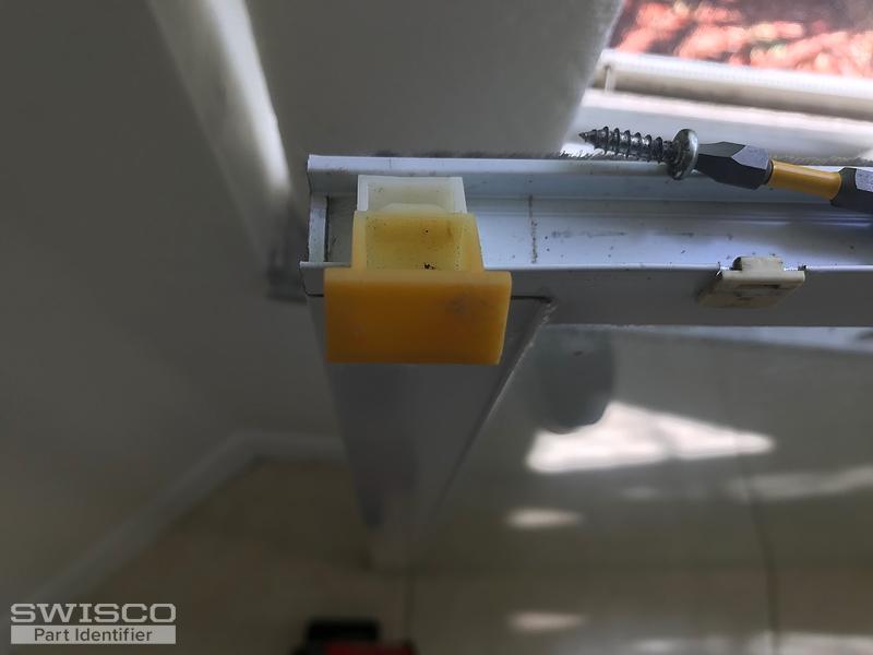 Clip that screws to the top of operative sash and retains spring ...