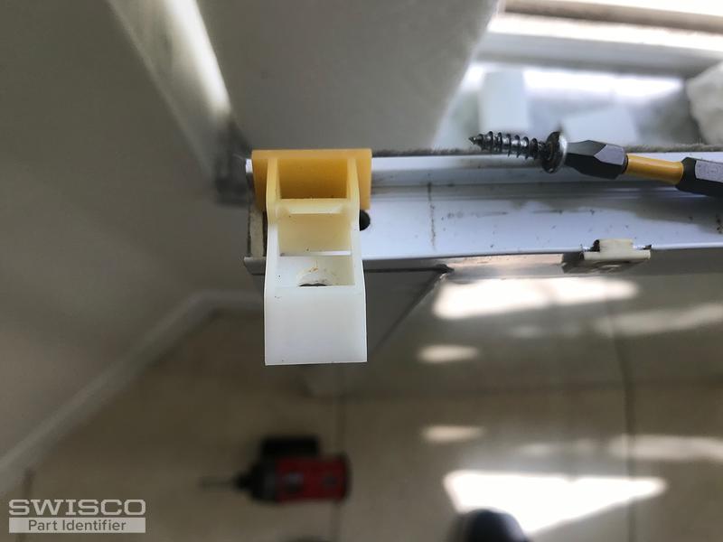 Clip that screws to the top of operative sash and retains spring ...