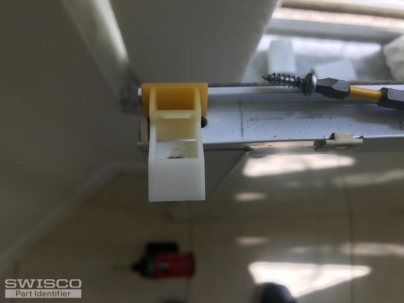 Clip that screws to the top of operative sash and retains spring ...