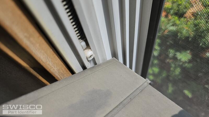 The part that connects the spring to the plastic piece the window locks ...